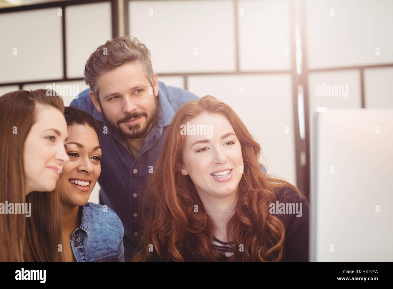 Happy business people using computer Stock Photo - Alamy