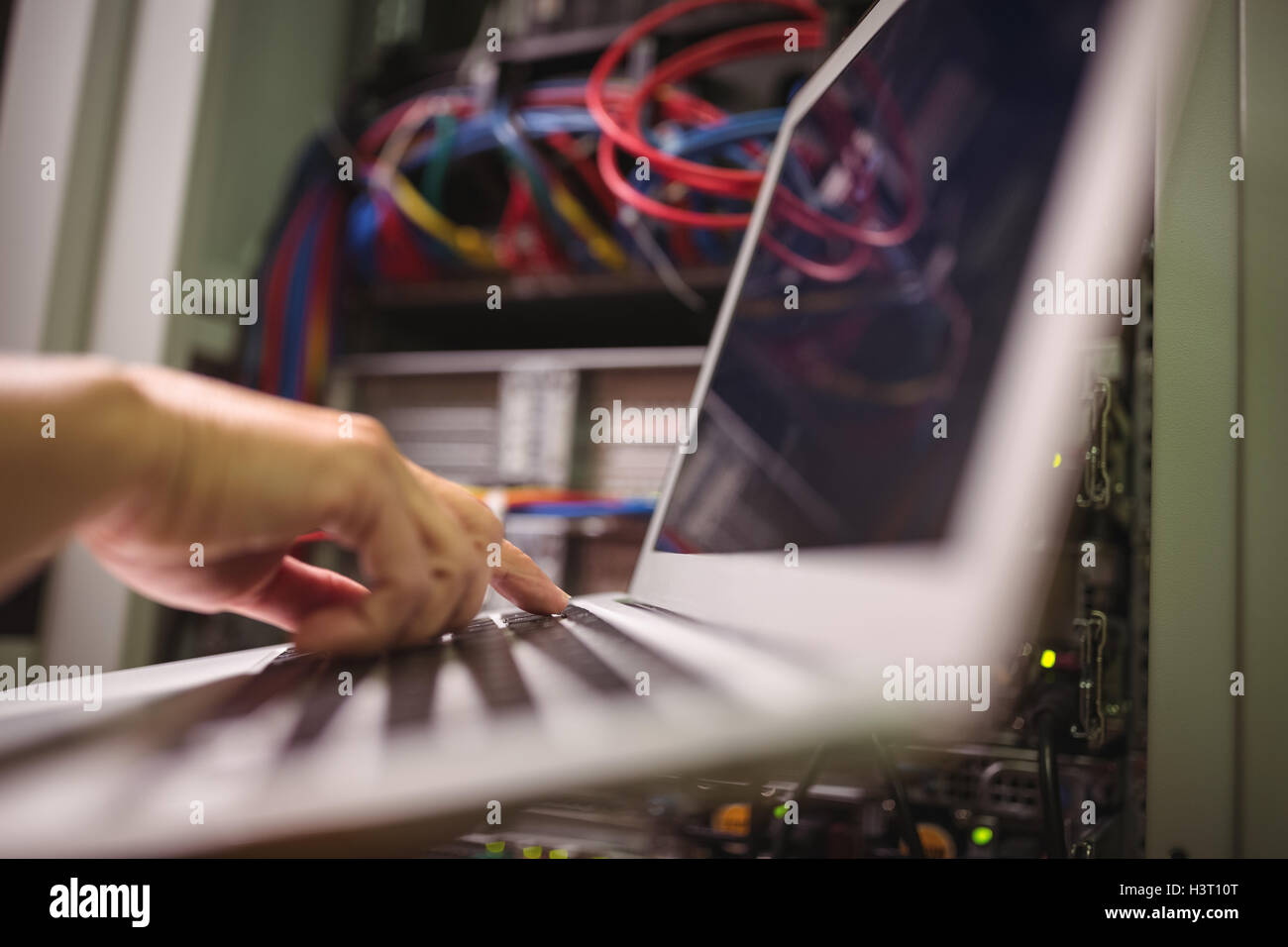 Technician working on laptop Stock Photo - Alamy