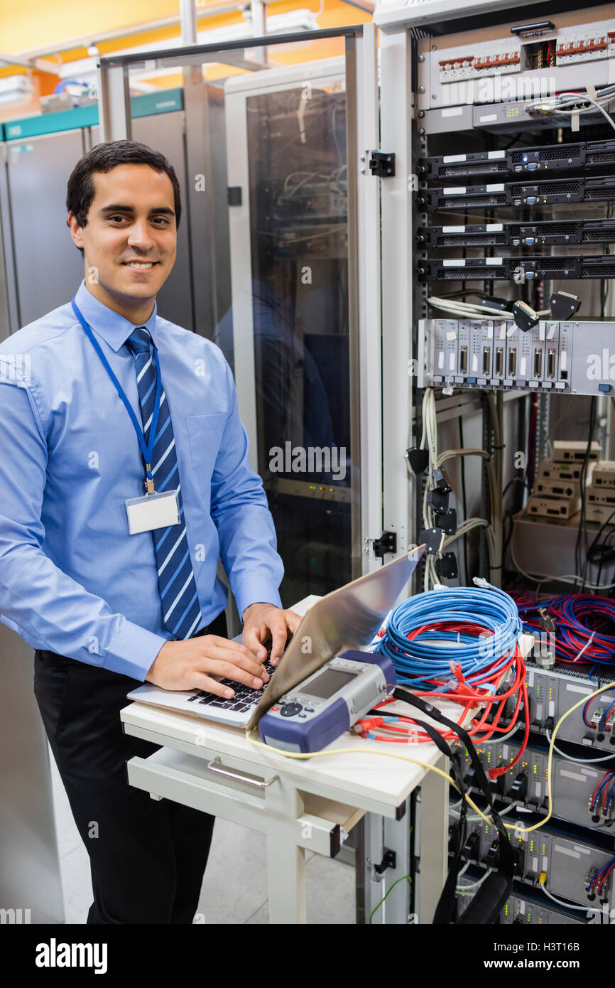 Technician working on laptop Stock Photo - Alamy