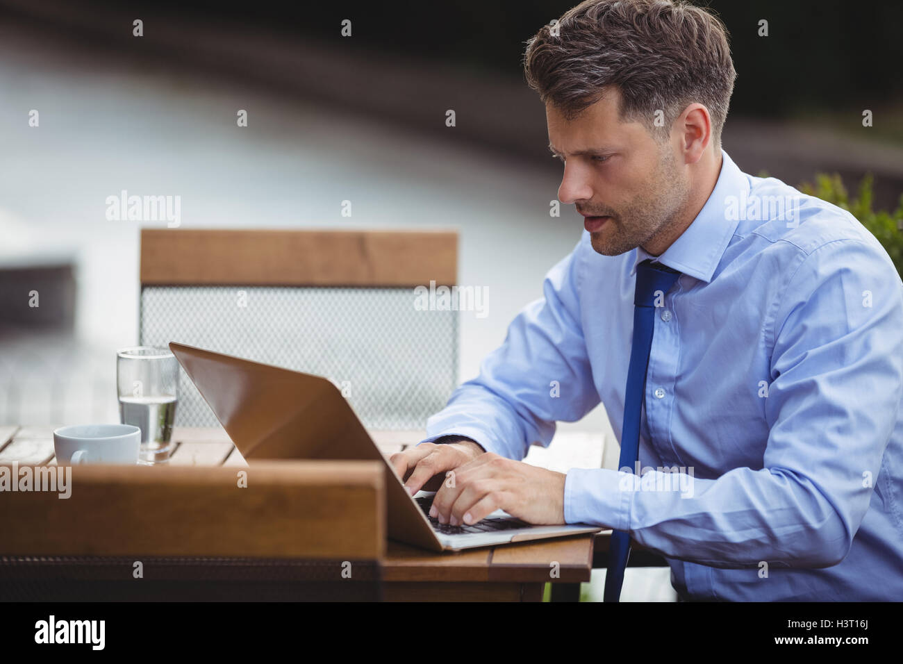 Handsome businessman using laptop Stock Photo - Alamy