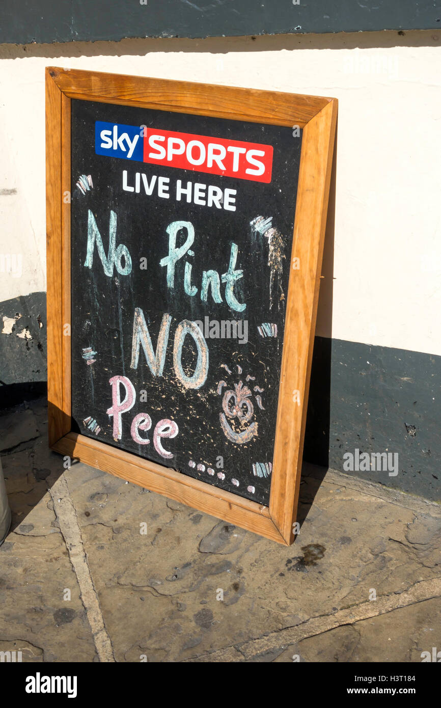 Sign on a blackboard outside a pub No Pint No Pee, only customers may ...
