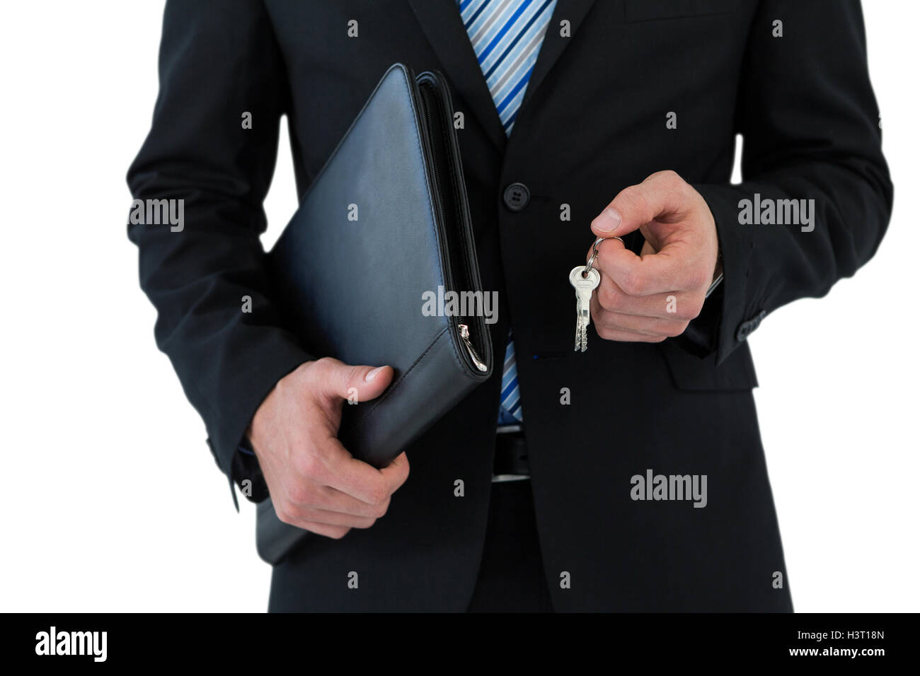 Mid section of businessman holding keys Stock Photo - Alamy