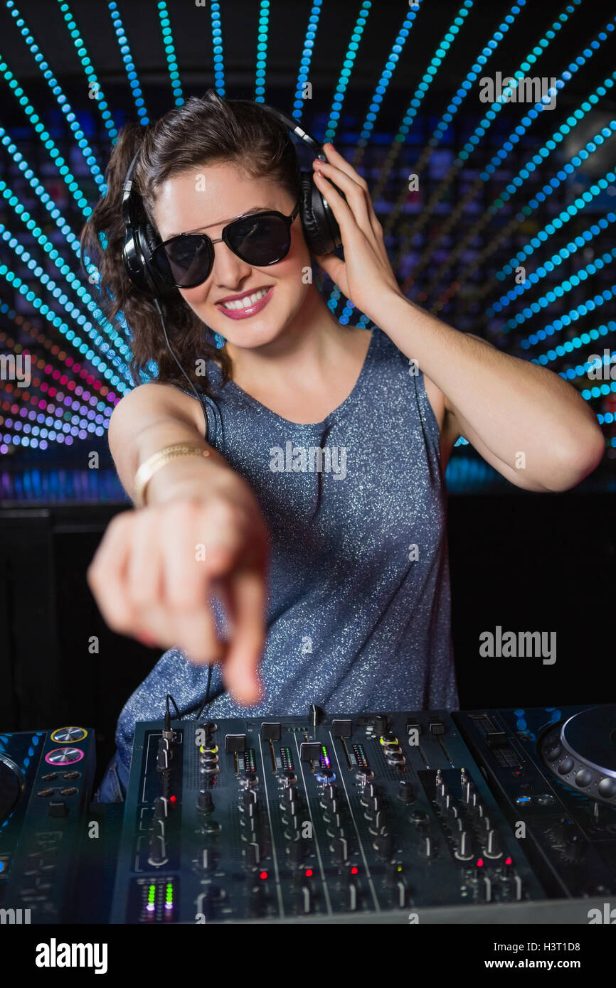 Pretty female DJ playing music Stock Photo - Alamy