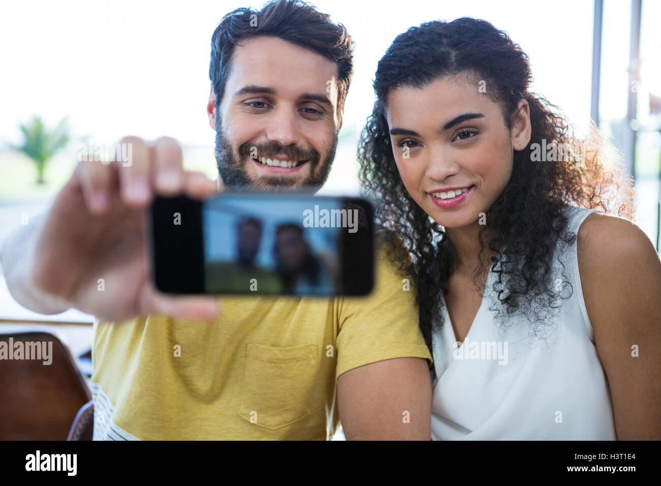 Smiling couple taking a selfie Stock Photo - Alamy