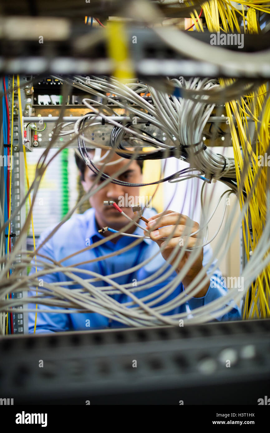 Technician fixing cable Stock Photo - Alamy