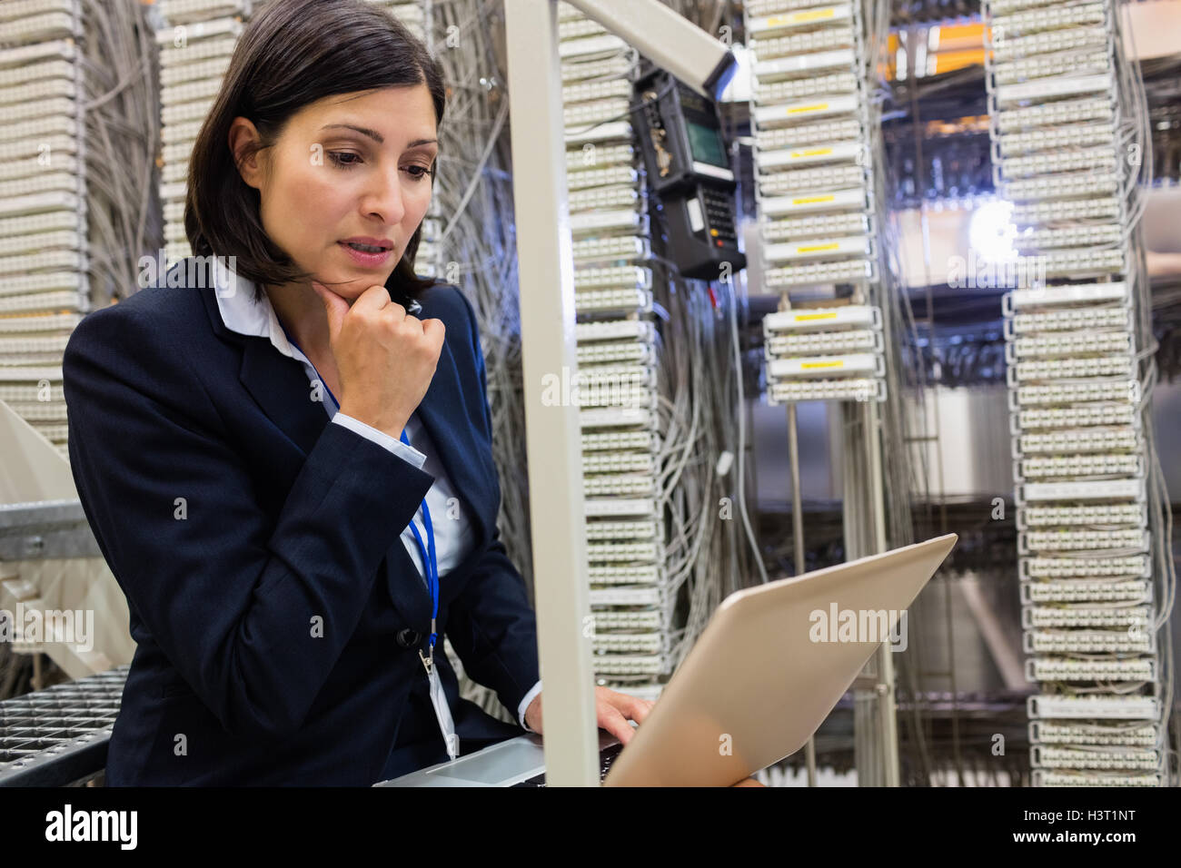 Technician working on laptop Stock Photo - Alamy