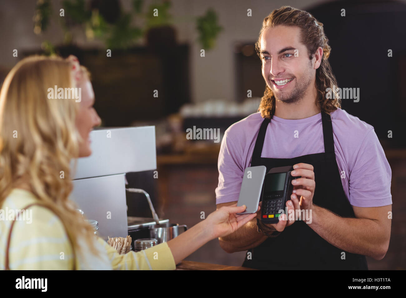 Woman paying bill through hi-res stock photography and images - Alamy