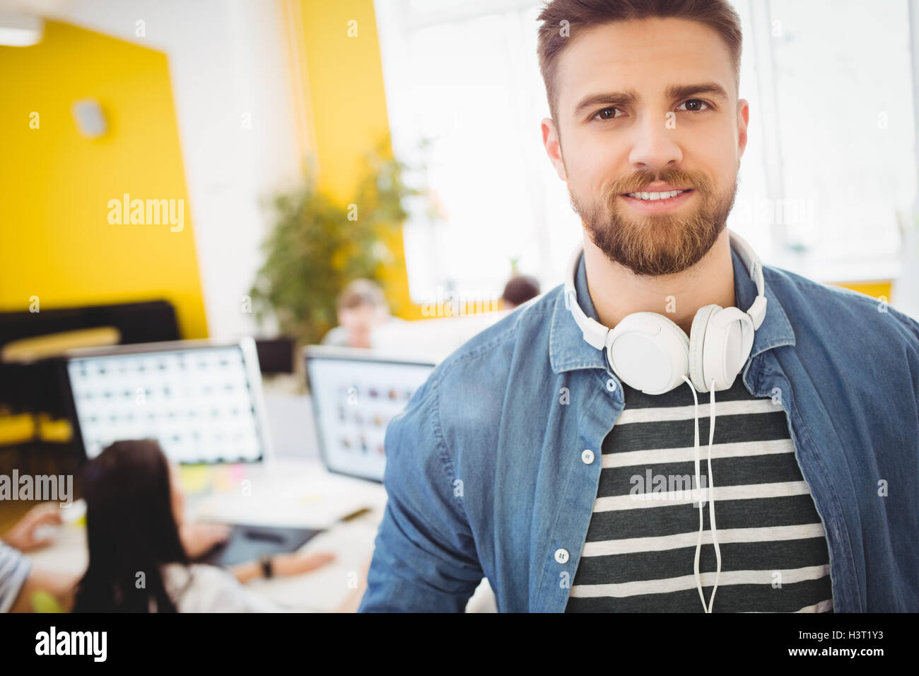 Portrait of handsome executive with headphones at creative office Stock ...