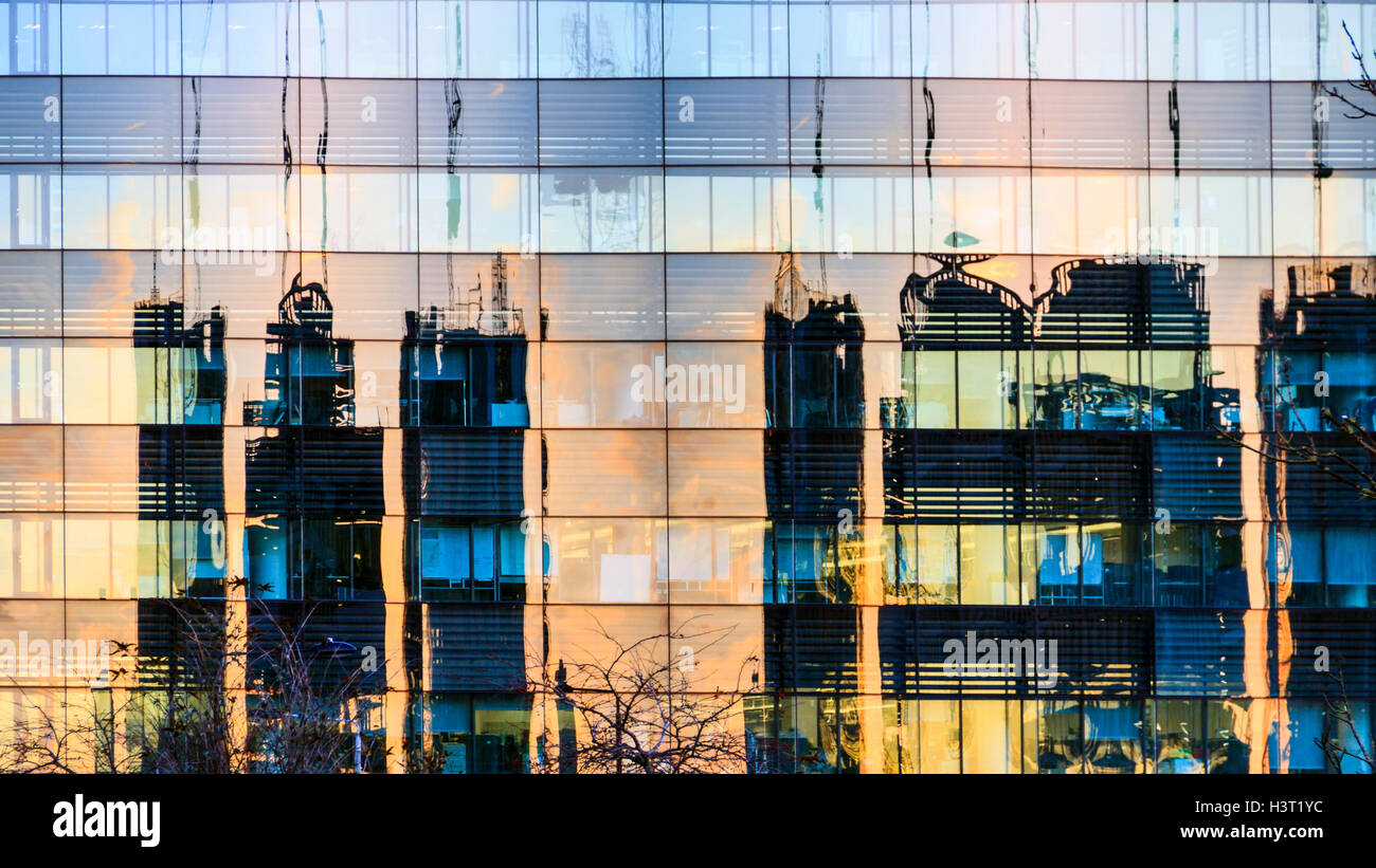 Colours of the sunset reflected in the glass façade of Kings Place ...