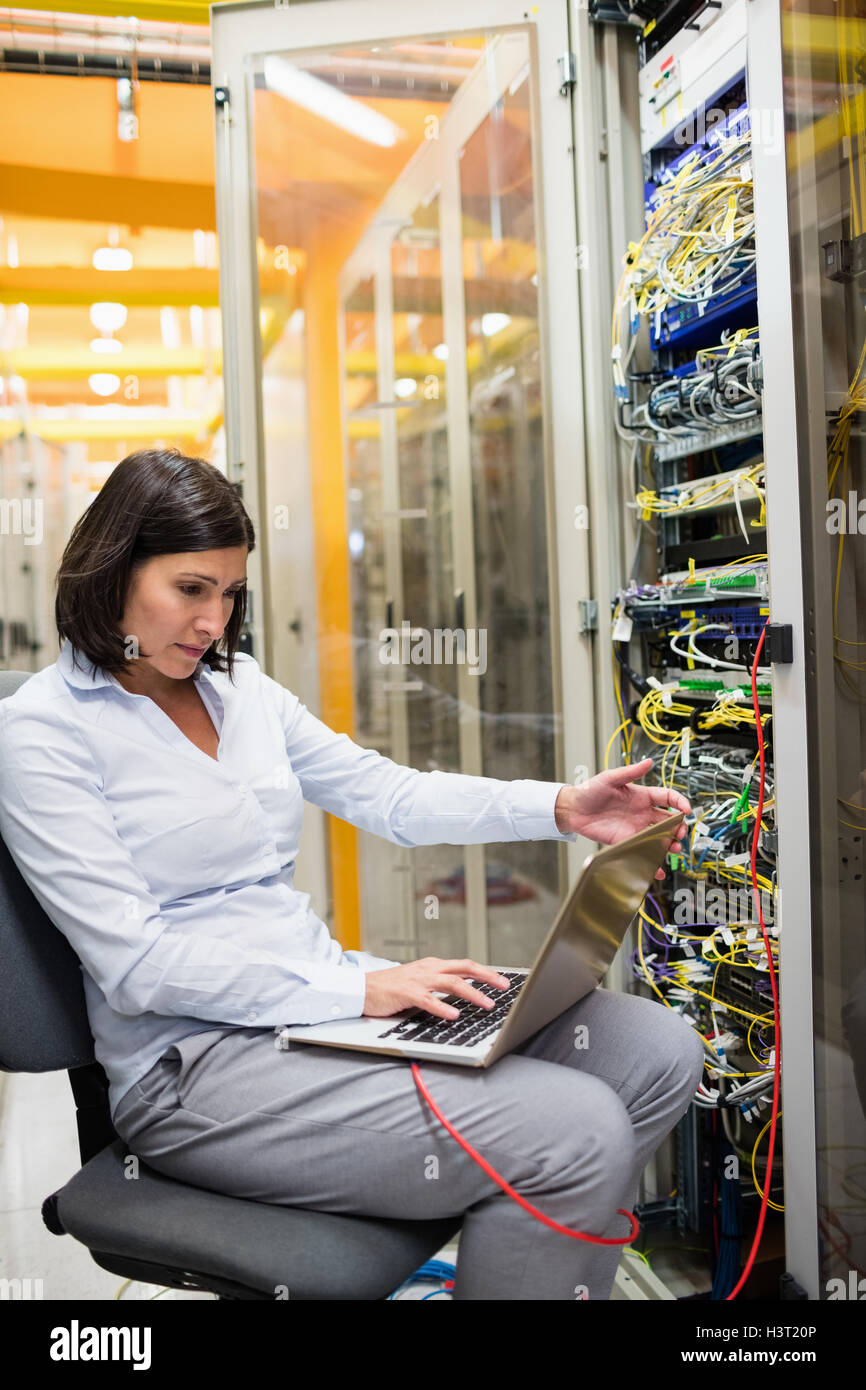 Technician working on laptop Stock Photo - Alamy