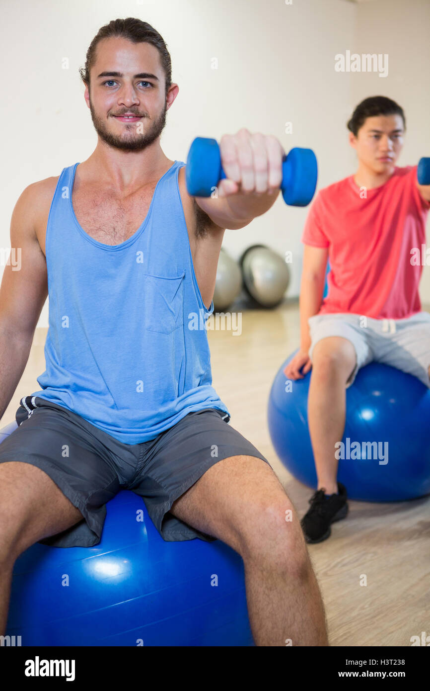 Men exercising on exercise ball Stock Photo - Alamy