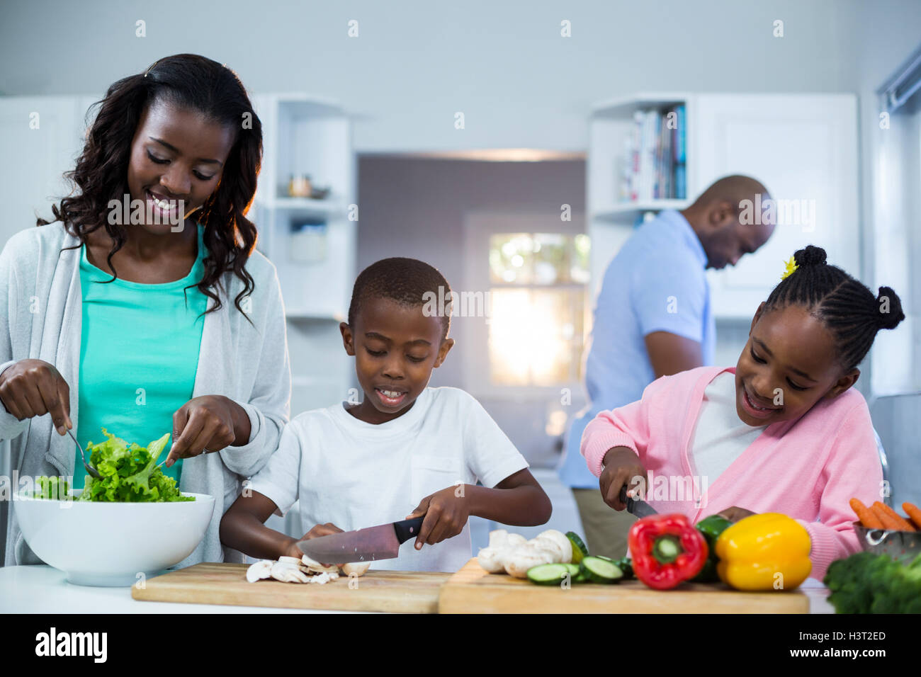 Happy family preparing food Stock Photo - Alamy