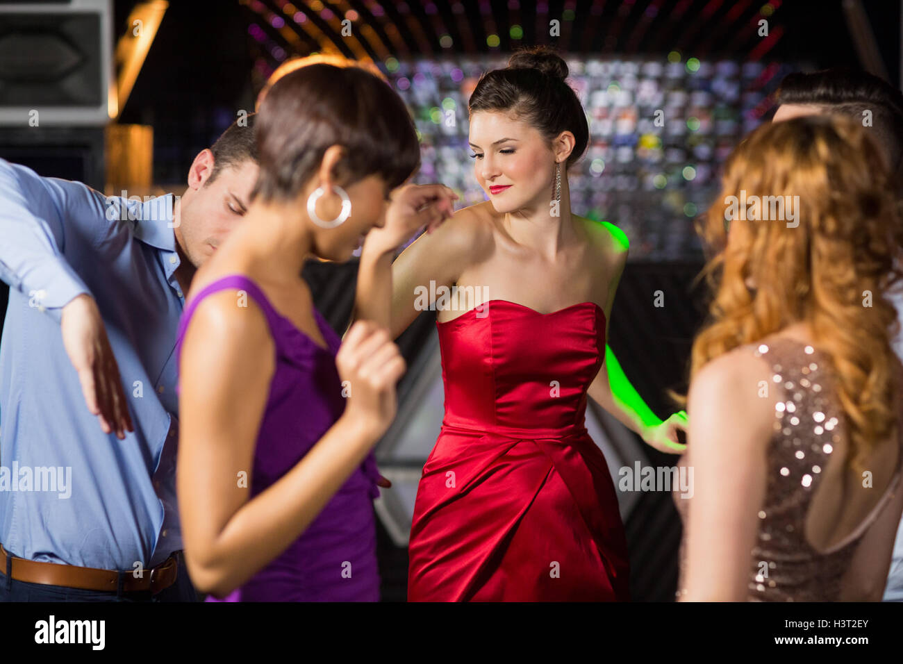 Smiling friends dancing on dance floor Stock Photo - Alamy