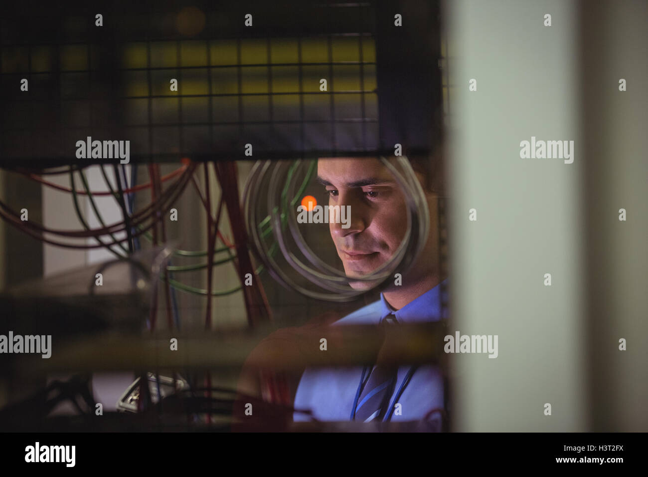 Technician checking cables in a rack mounted server Stock Photo - Alamy