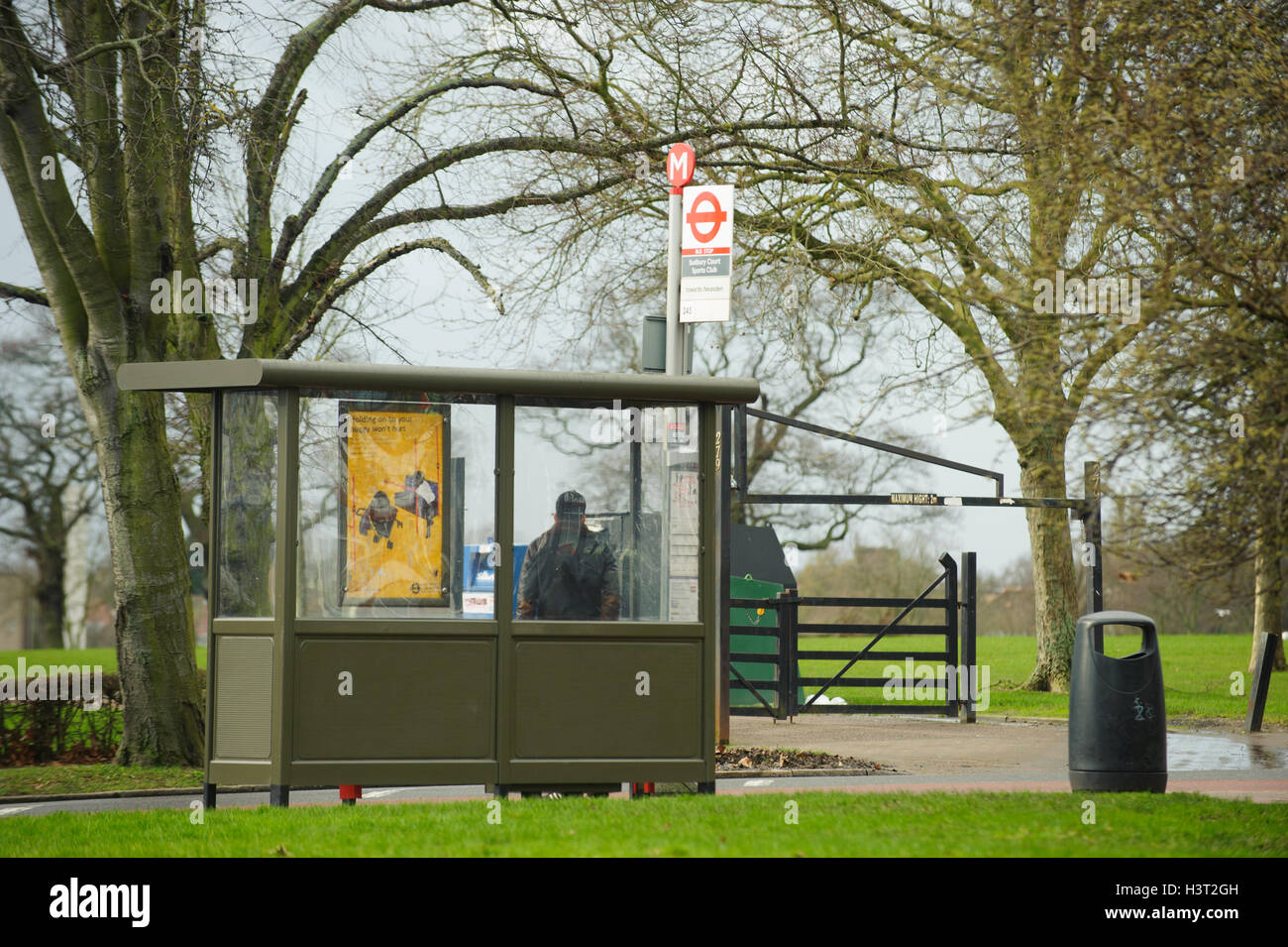 man waiting alone for a bus at a bus stop Stock Photo - Alamy