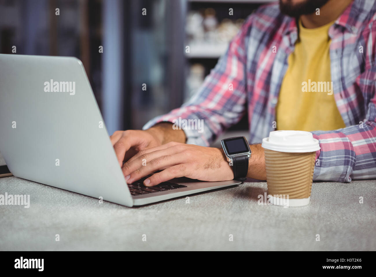 Mid-section of man using laptop Stock Photo - Alamy