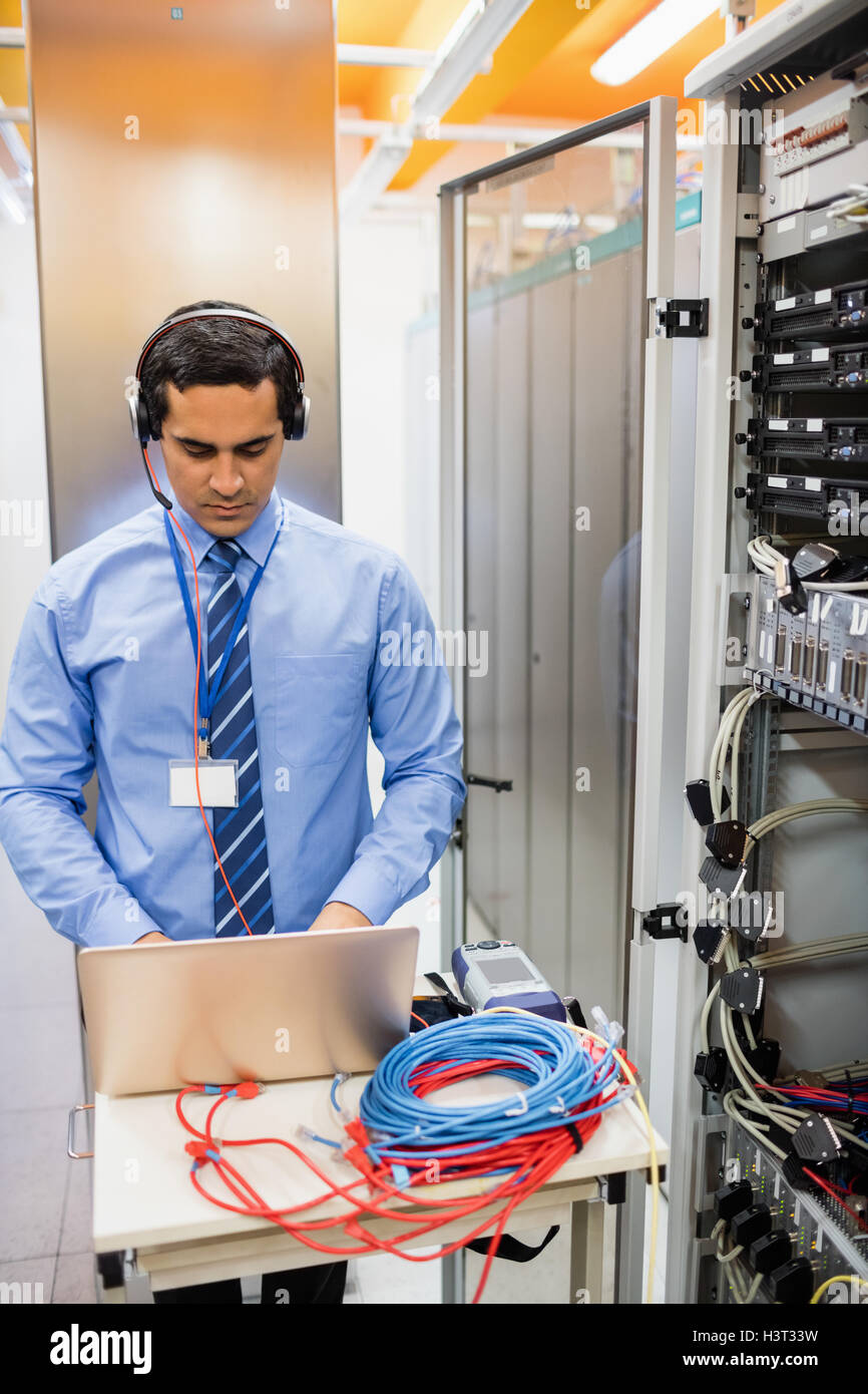 Technician laptop checking server in hi-res stock photography and ...