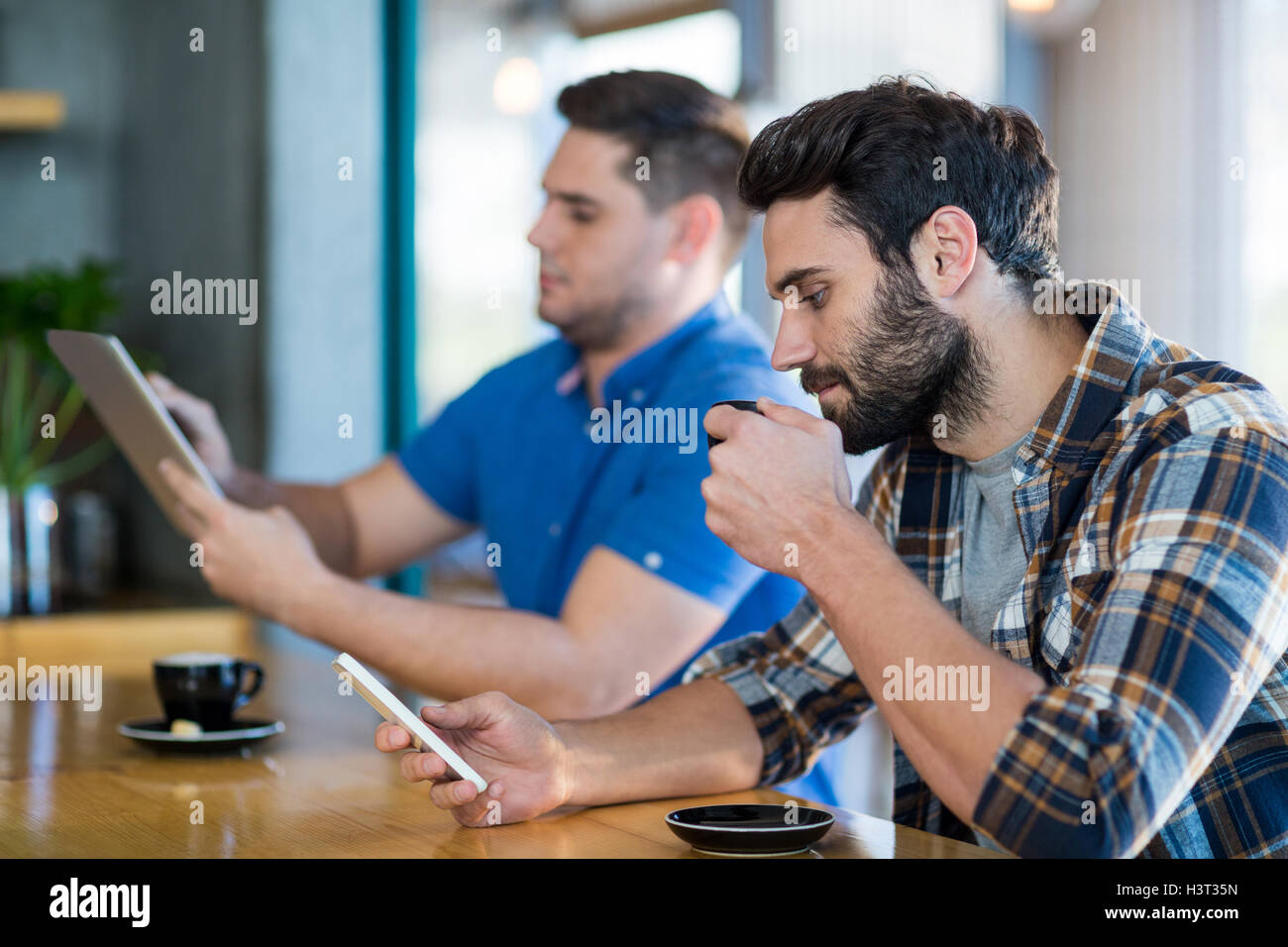 Handsome men using digital hi-res stock photography and images - Alamy