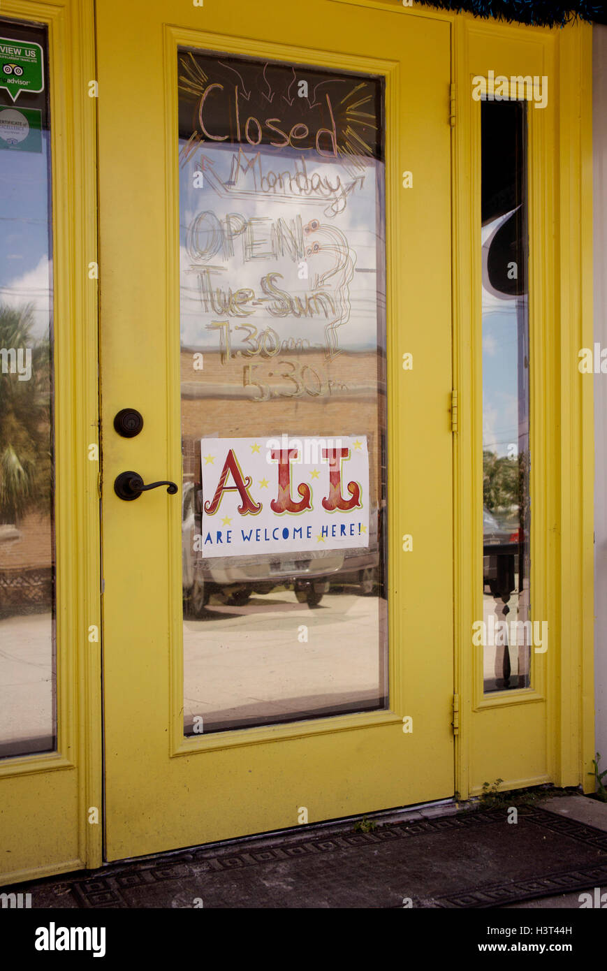 Store sign indicating "ALL are welcome Stock Photo - Alamy