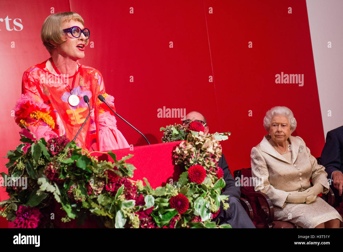 Queen Elizabeth II listens to Grayson Perry speak during a reception ...