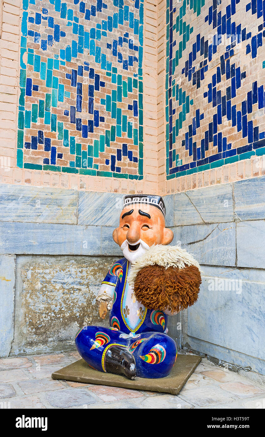The dall of the smiling Uzbek old man in the courtyard of Tilya Kori ...