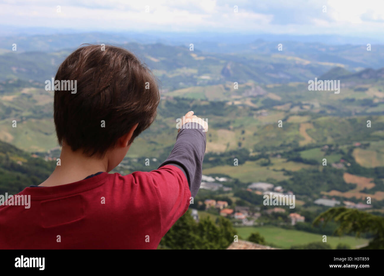 young boy shows the beautiful landscape of the Apennines in Italy Stock ...