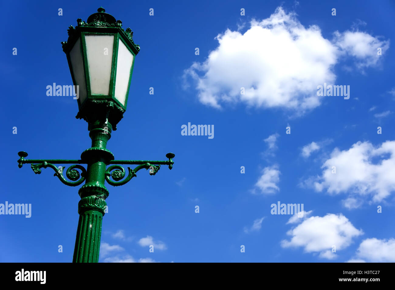 green street lamp post on blue sky background Stock Photo - Alamy