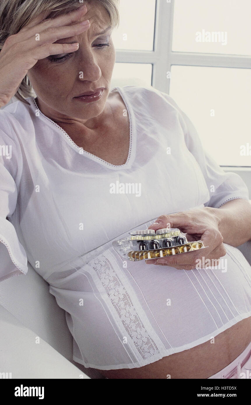 Woman, pregnant, vitamin pills, thoughtful gestation, pregnant, at home ...
