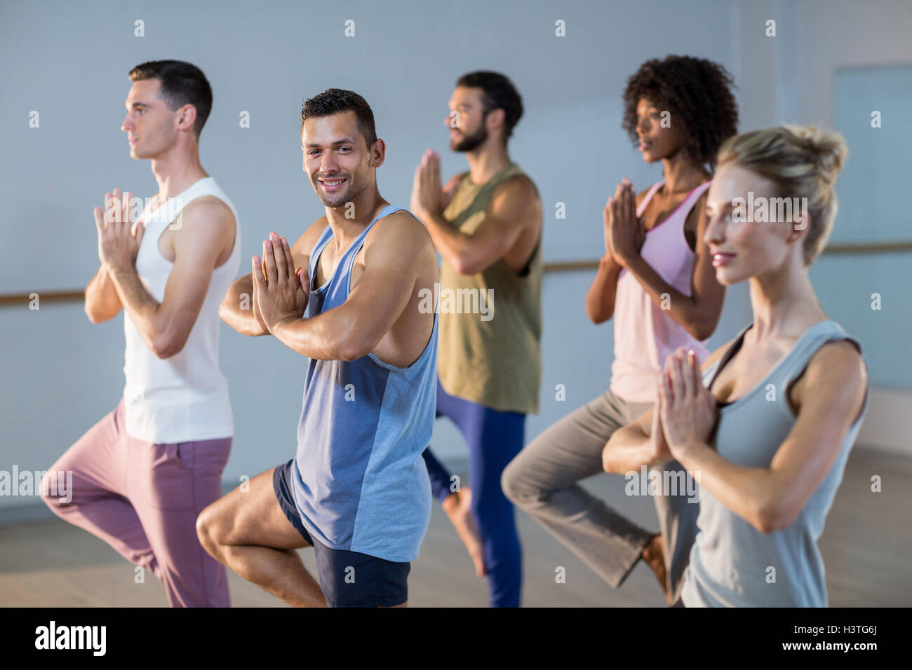 Group of people performing yoga Stock Photo - Alamy