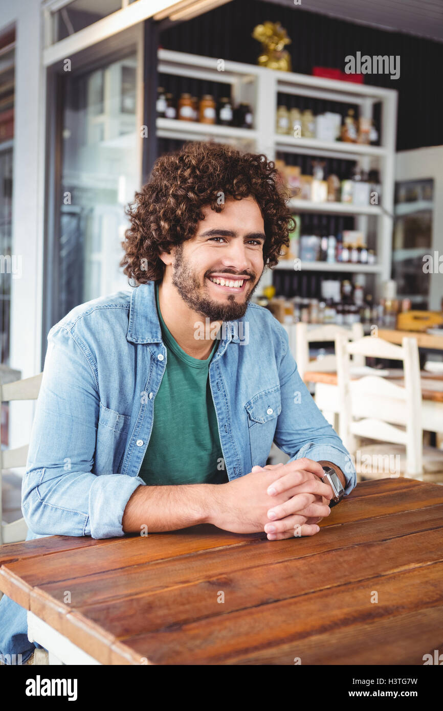 Man sitting and smiling Stock Photo - Alamy
