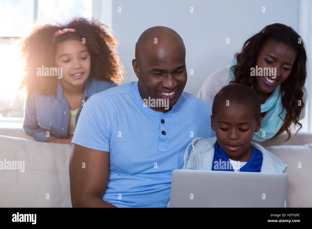 Happy family using laptop Stock Photo - Alamy