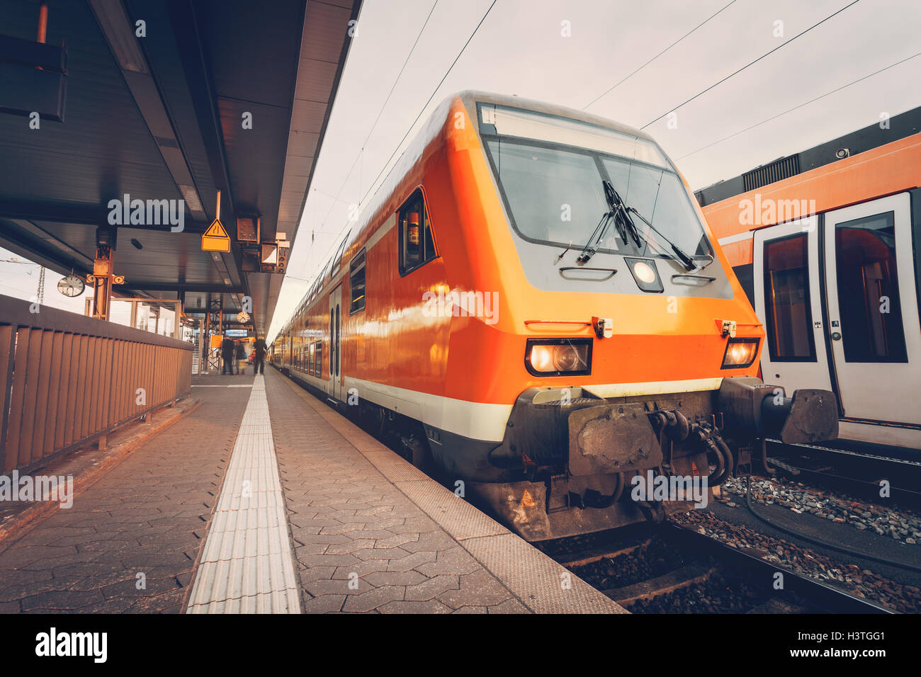Modern high speed orange commuter train at colorful sunset. Beautiful ...