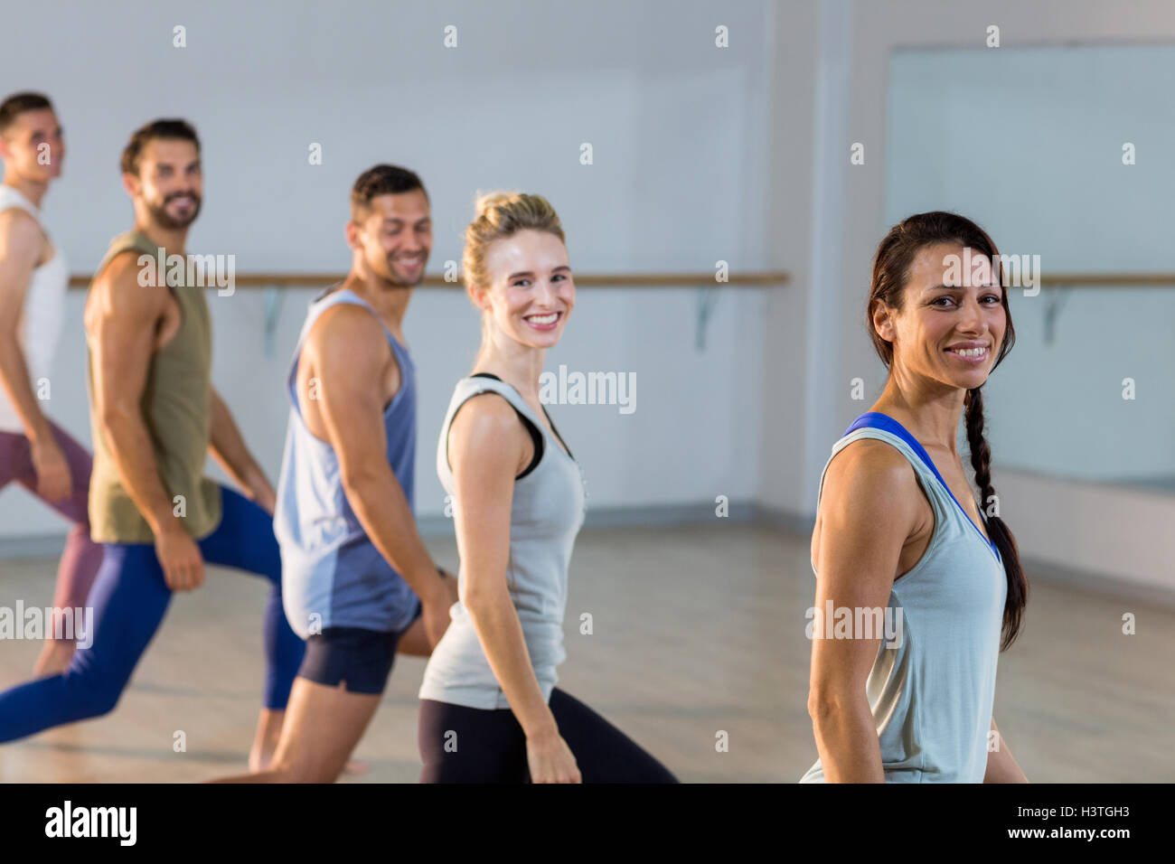 Group of fitness team performing stretching exercise Stock Photo - Alamy