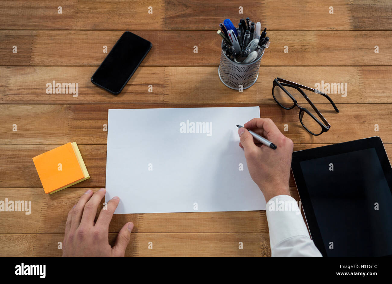 Businessman writing on a document Stock Photo - Alamy