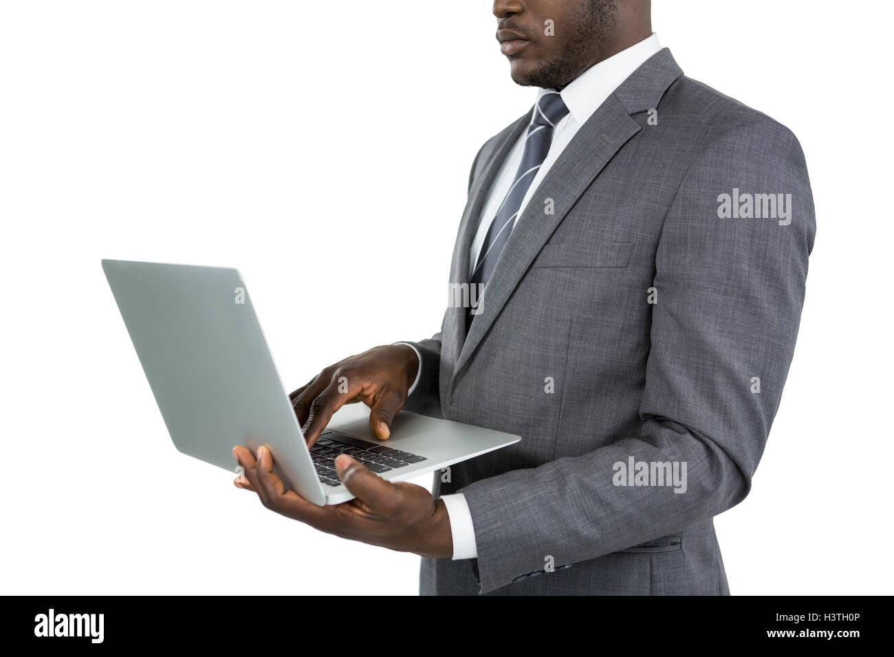 Mid section of businessman using laptop Stock Photo - Alamy