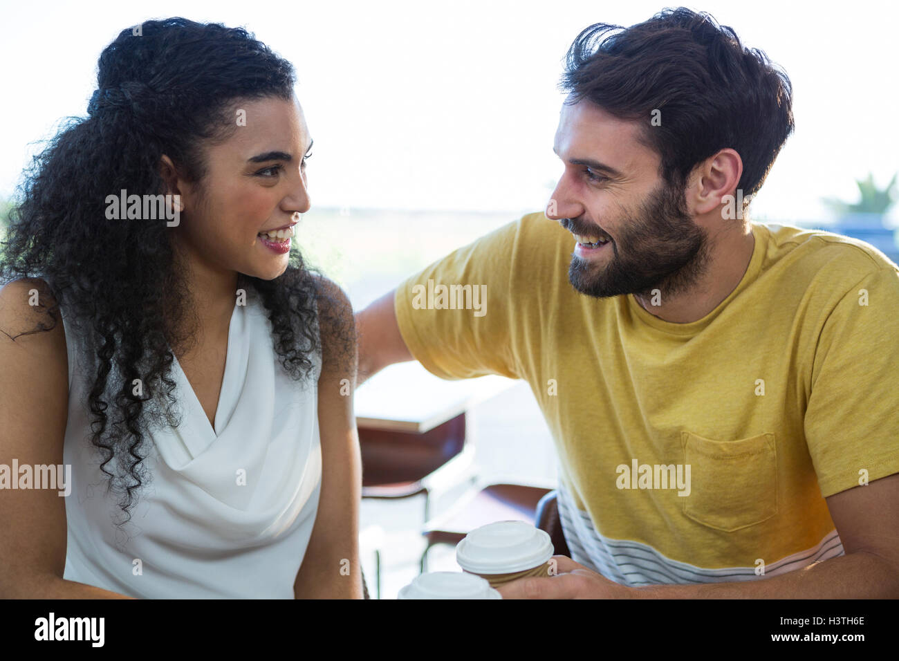 Couple talking to each other in coffee shop Stock Photo - Alamy