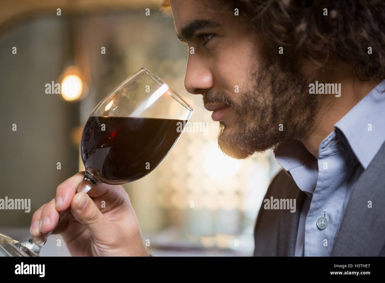 Businessman having glass of red wine Stock Photo - Alamy