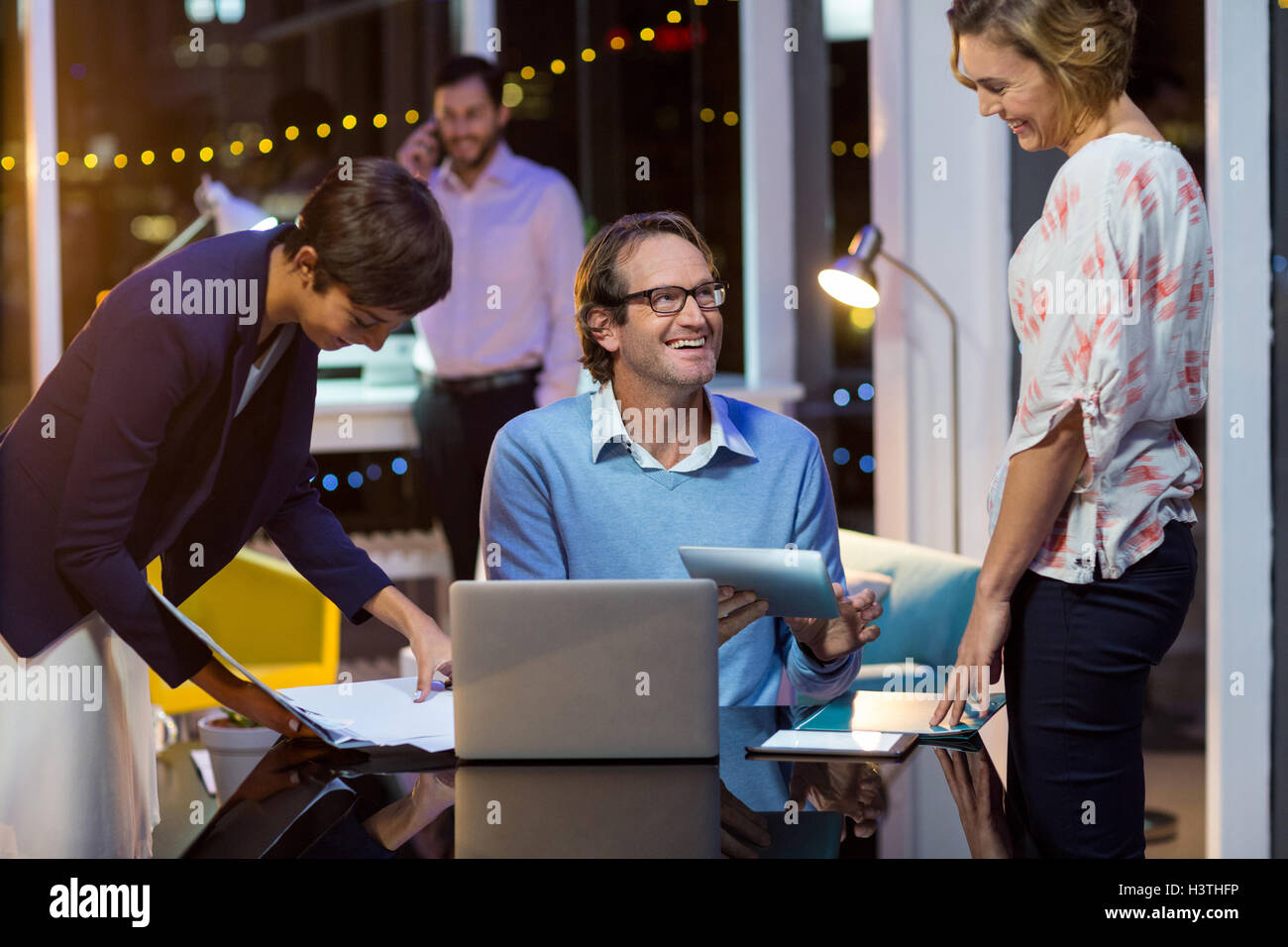 Businesspeople interacting with each other Stock Photo - Alamy