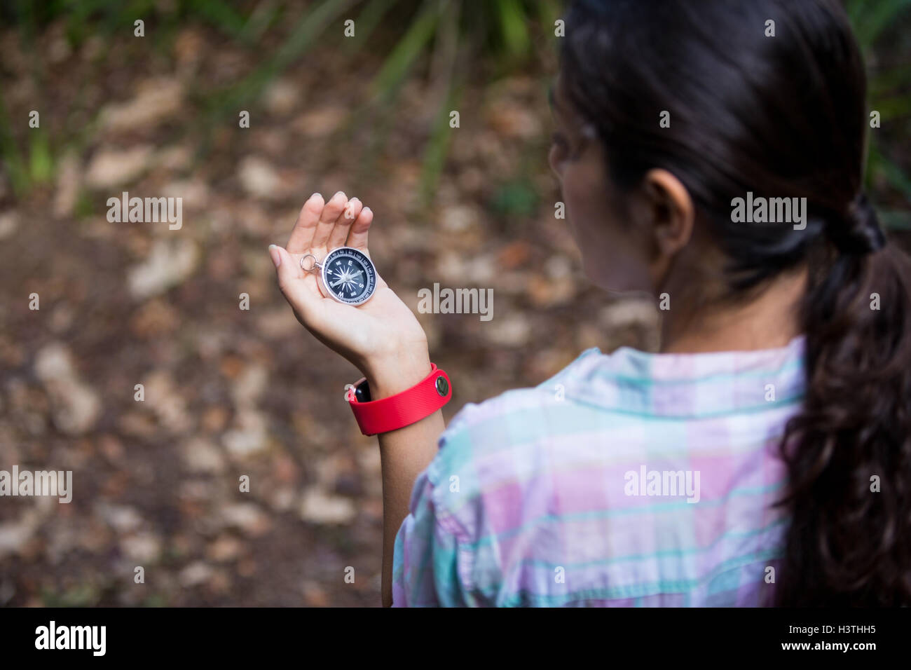 Female hiker looking at compass Stock Photo - Alamy