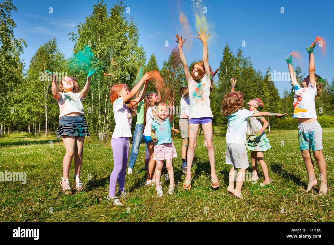 Kids playing with colored powder at outdoor fest Stock Photo - Alamy