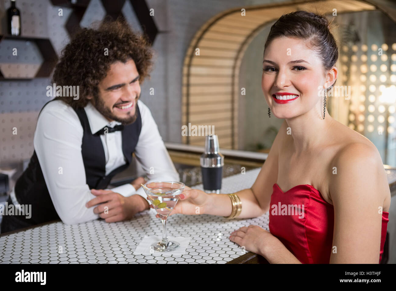 Portrait of beautiful woman standing at bar counter Stock Photo - Alamy