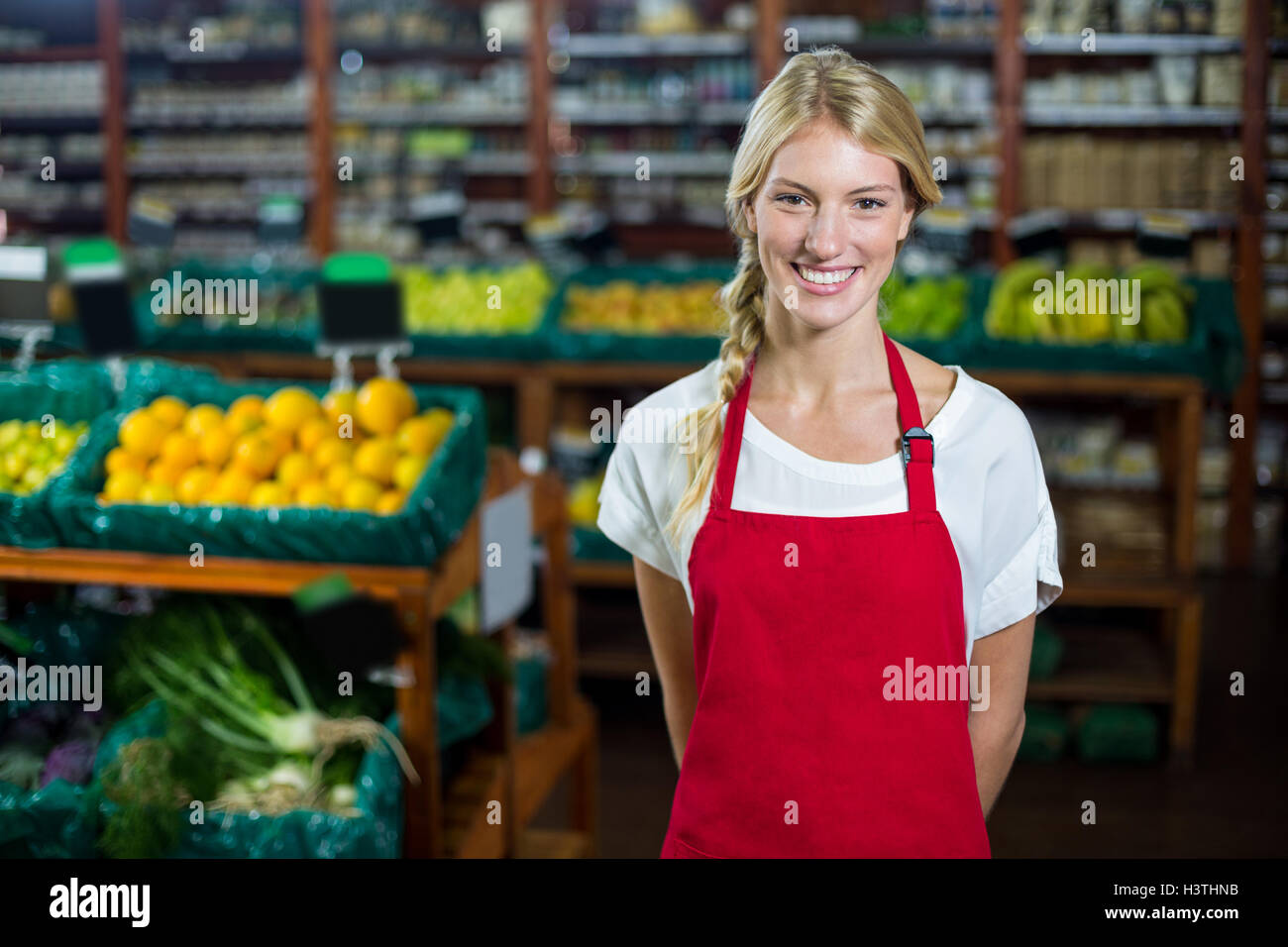 Smiling female staff standing in organic section Stock Photo - Alamy