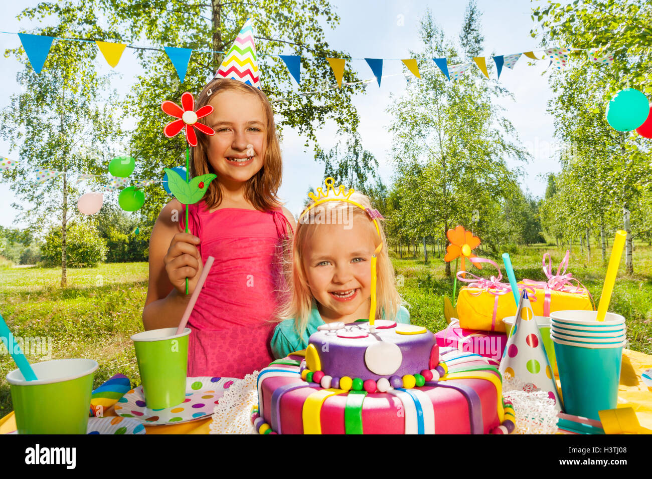 Two girls having fun at the outdoor birthday party Stock Photo - Alamy