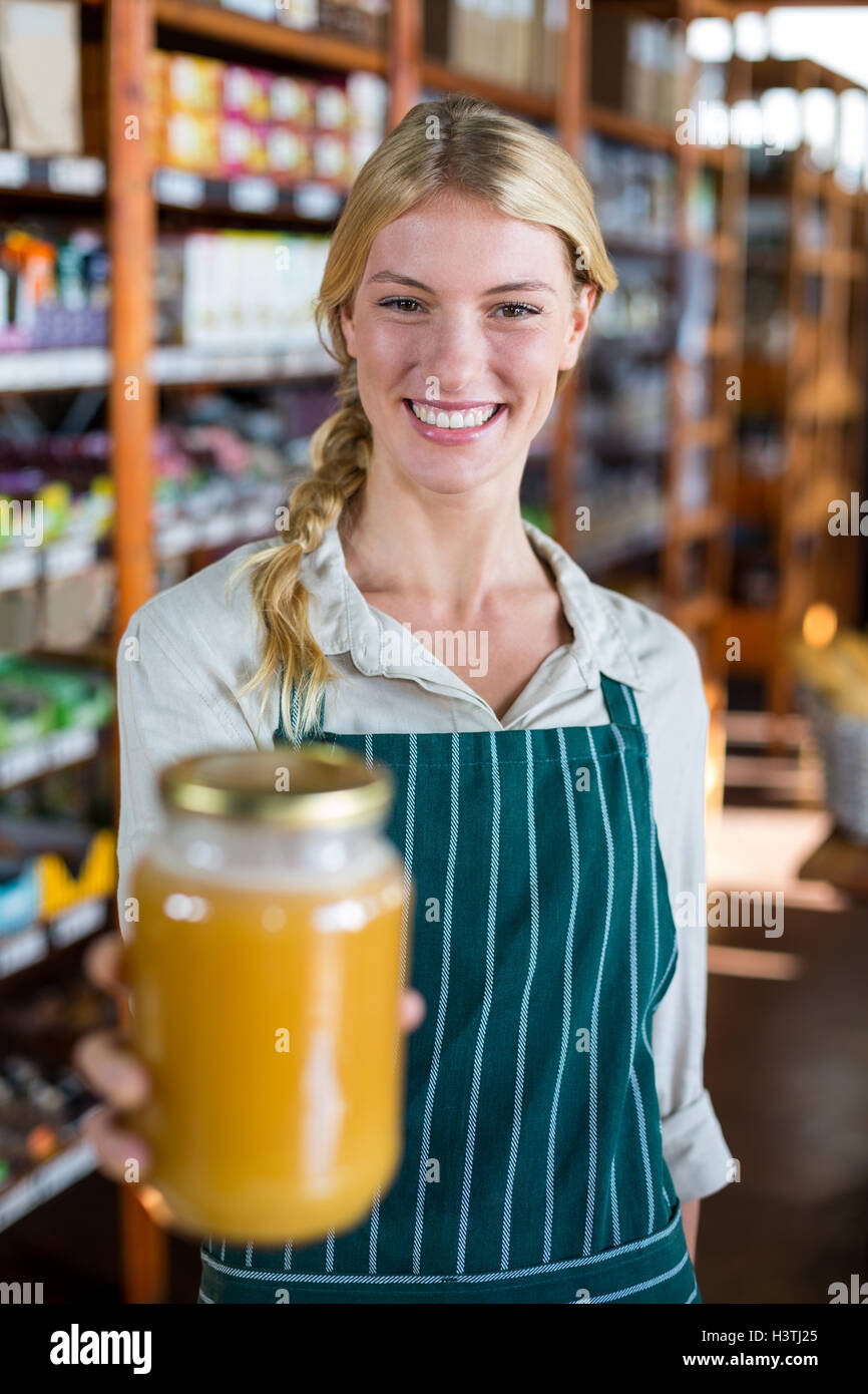 Young woman holding honey jar hi-res stock photography and images - Alamy