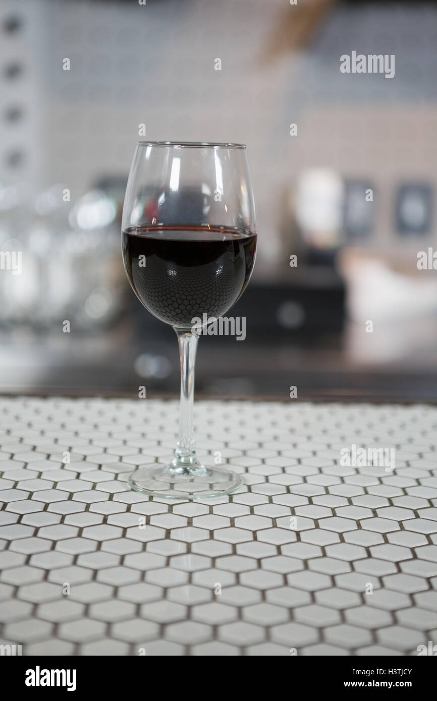 Glass of red wine on counter Stock Photo - Alamy
