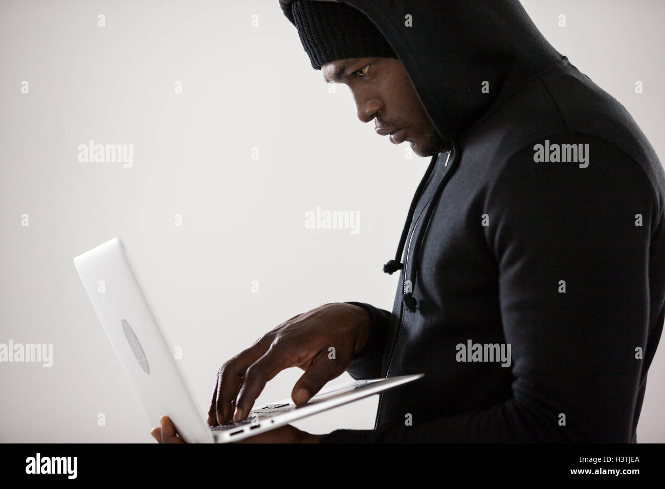 Hacker using white laptop hi-res stock photography and images - Alamy