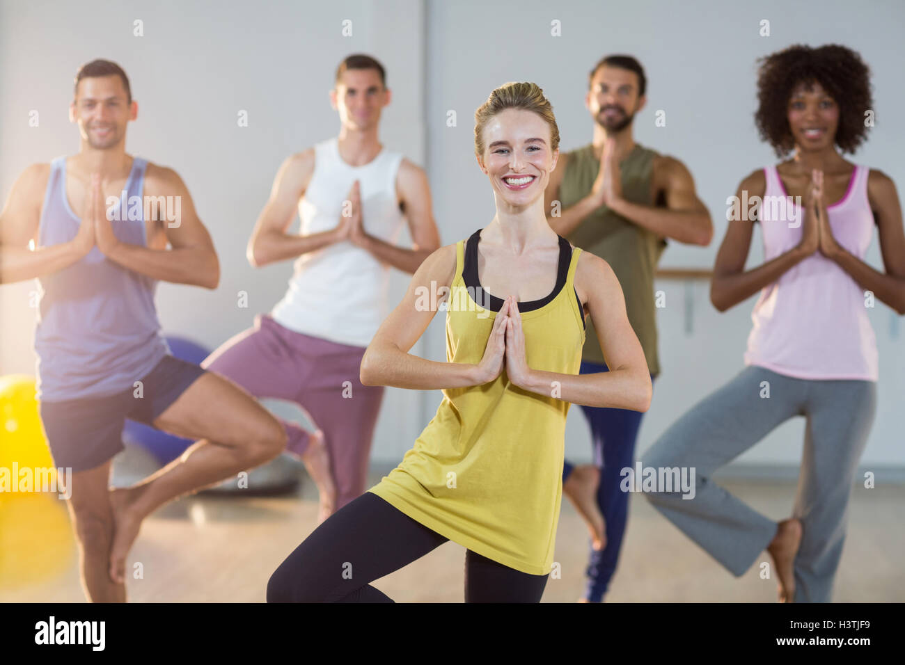 Group of people performing yoga Stock Photo - Alamy