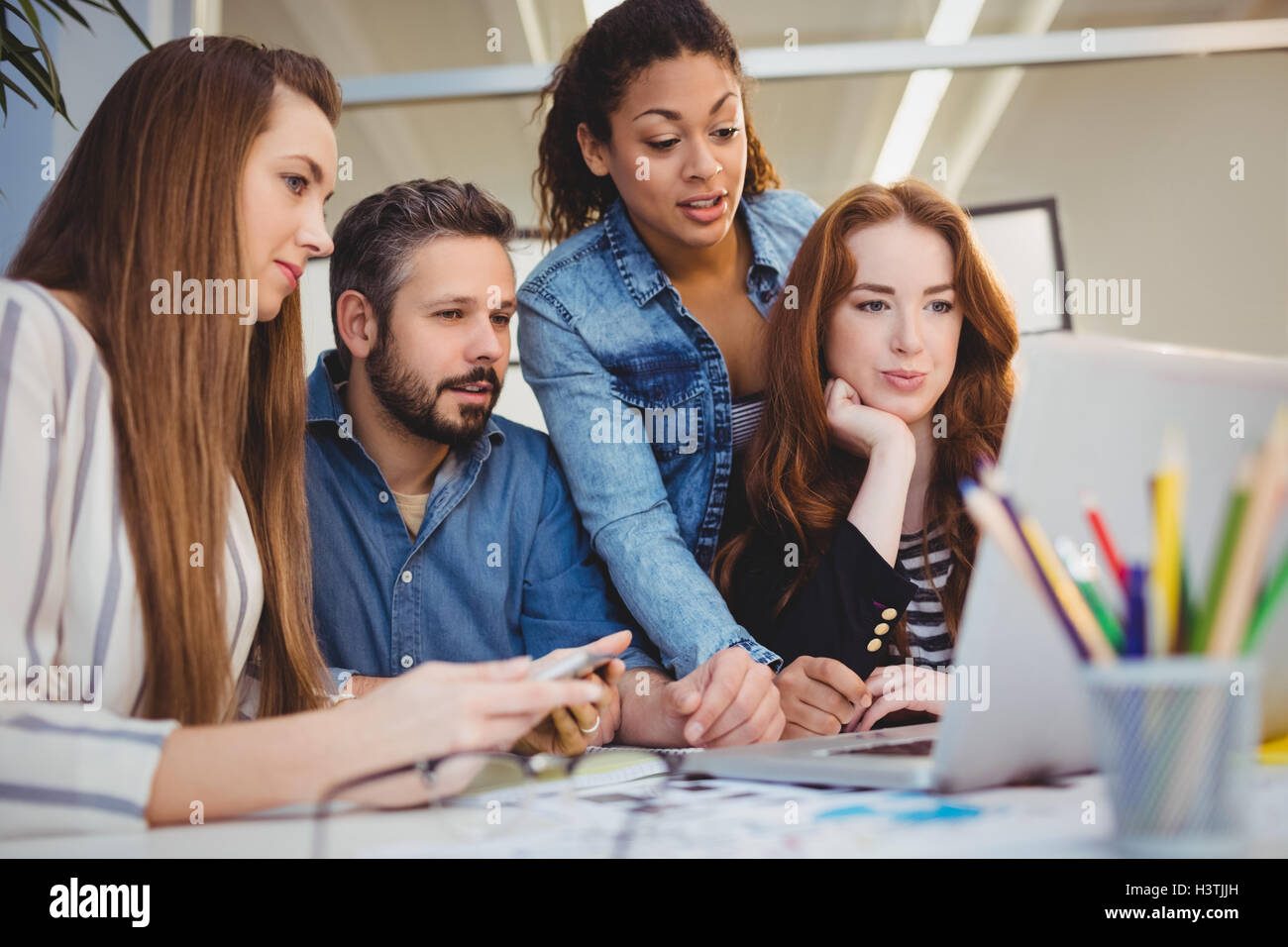Creative business people using laptop Stock Photo - Alamy