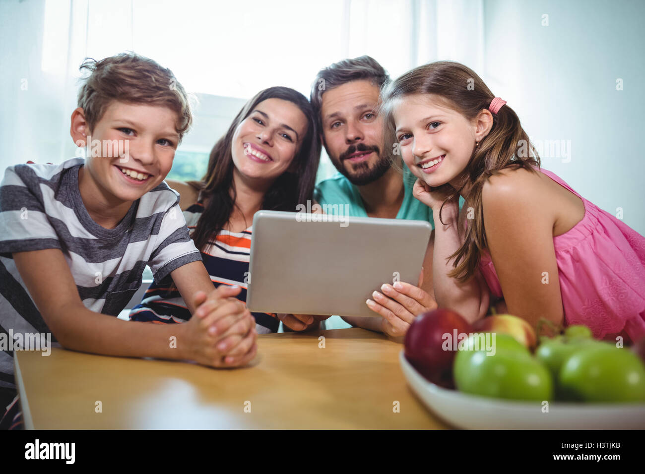 Happy family sitting table fruits hi-res stock photography and images ...