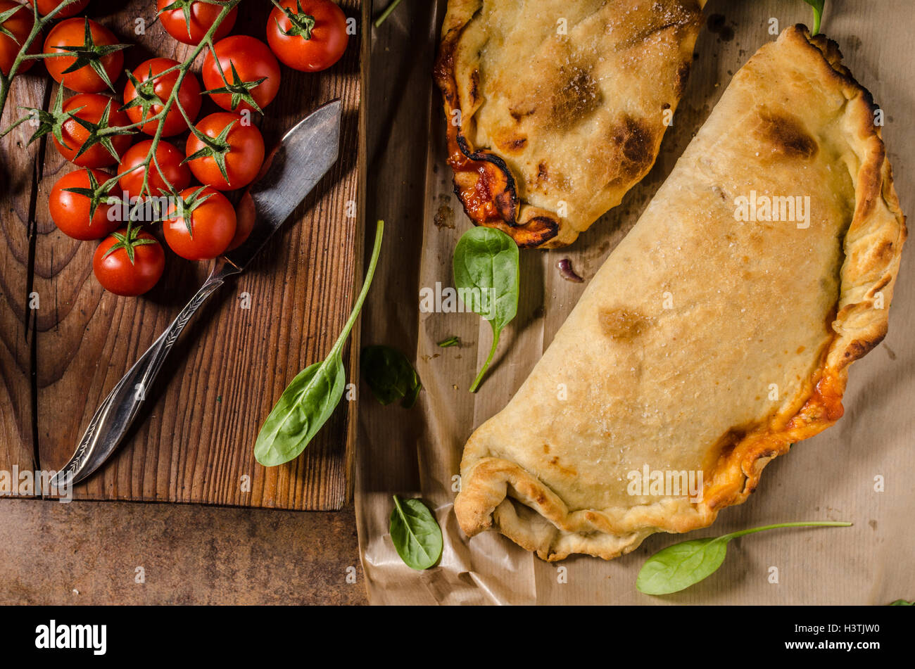 Calzone pizza, stuffed with tomato and herbs sauce, baked to crispy Stock Photo - Alamy